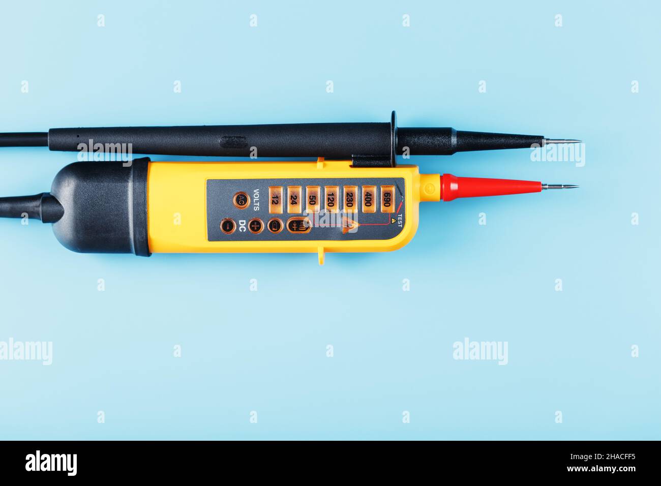 Two-pole voltage indicator close-up on a blue background. Testing and ...
