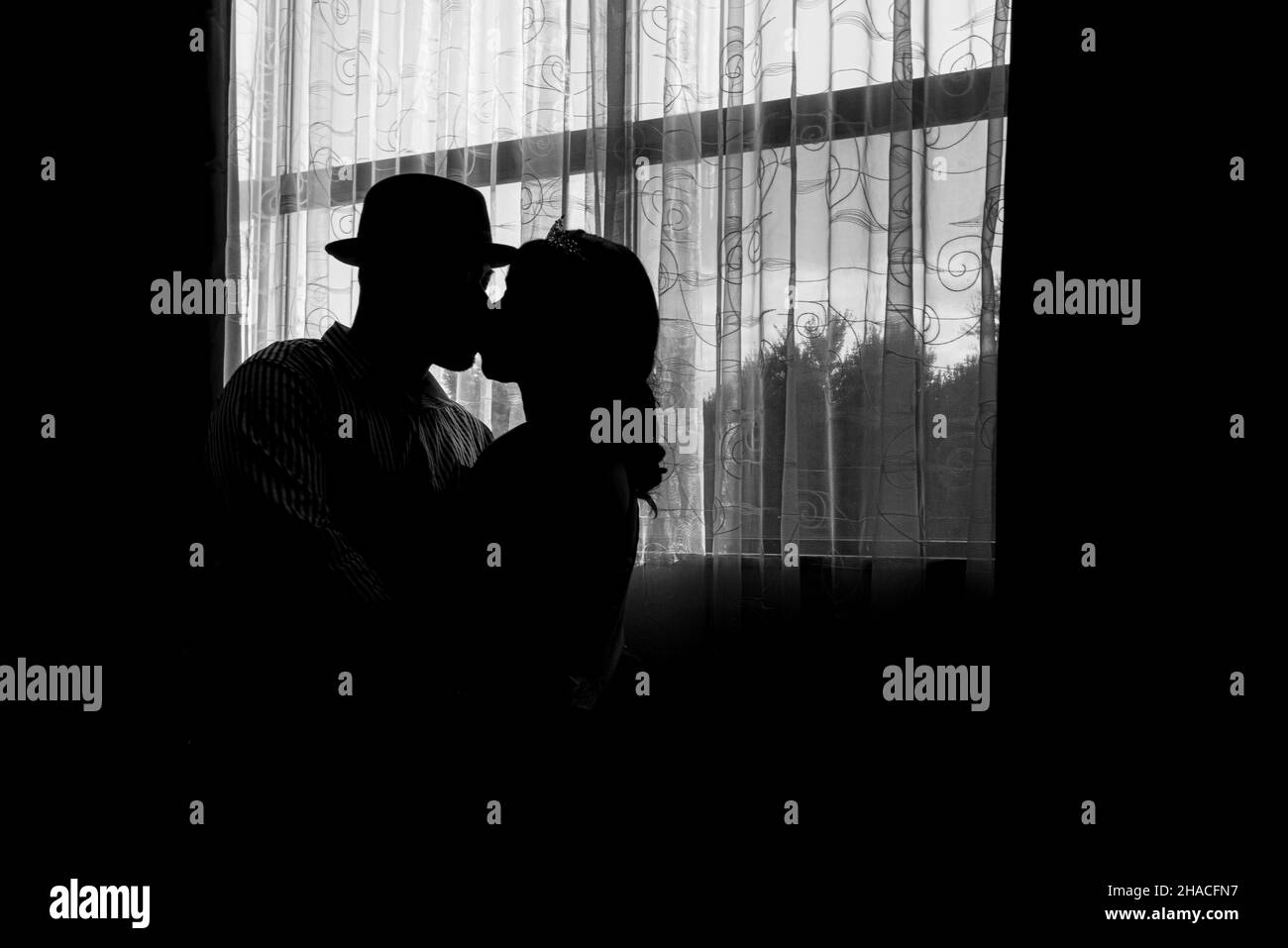 A beautiful greyscale shot of a romantic couple kissing Stock Photo - Alamy