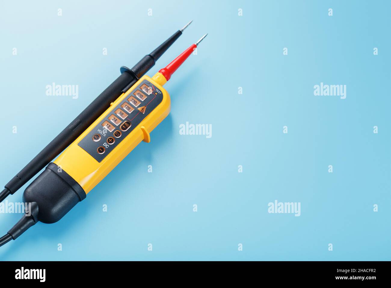 Two-pole voltage indicator close-up on a blue background. Testing and ...