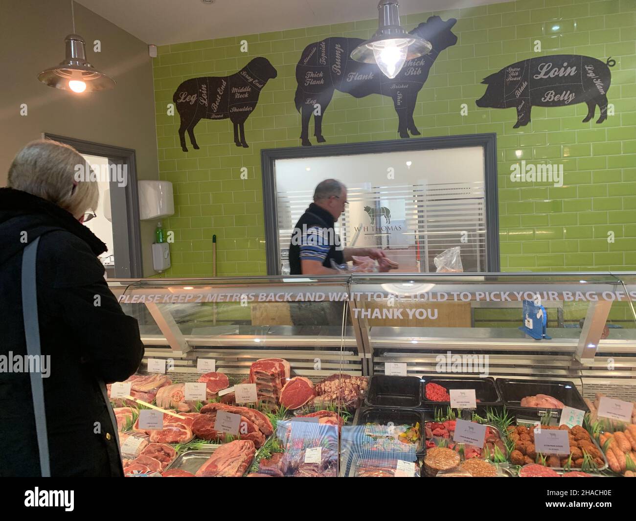 Butcher on a farm Ecton Northamptonshire UK customer butchers cabinet ...
