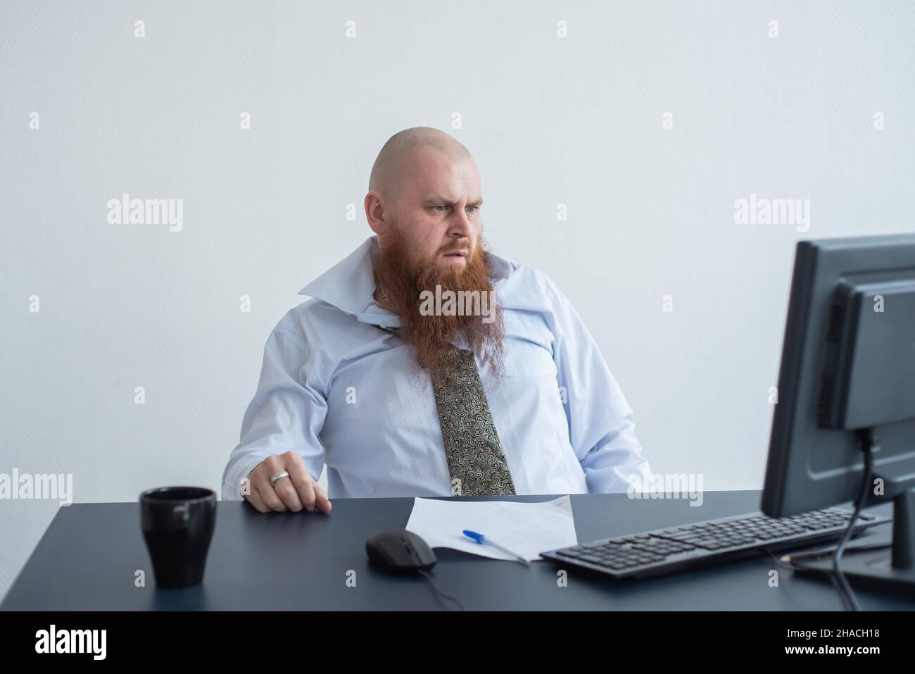 Problems for the office worker. A bald man in a white shirt sits at a ...
