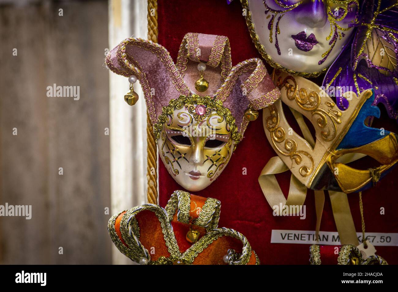 A closeup of Venetian colorful traditional Carnaval masks hanging on a ...
