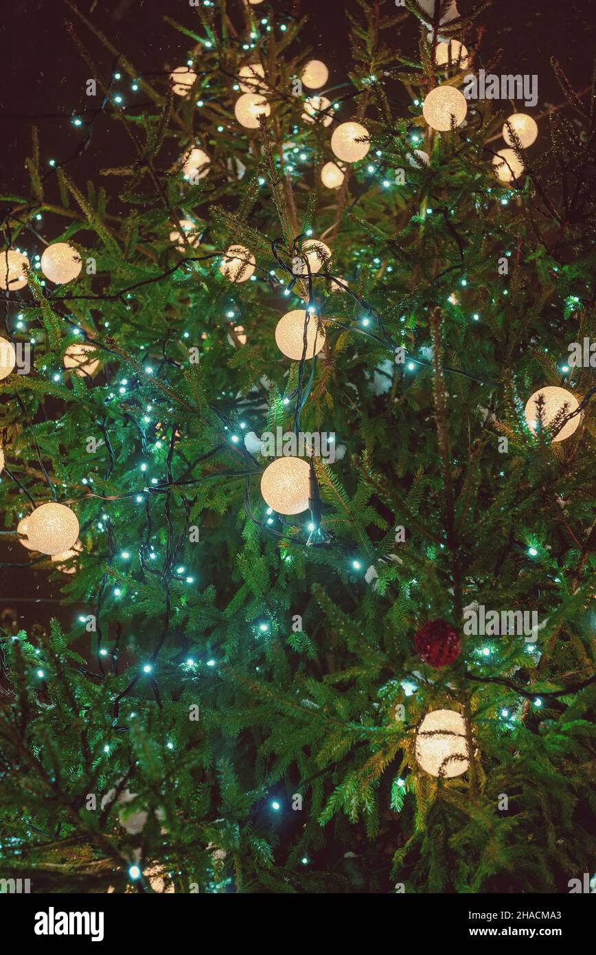 New Year tree with balls in the park Stock Photo - Alamy