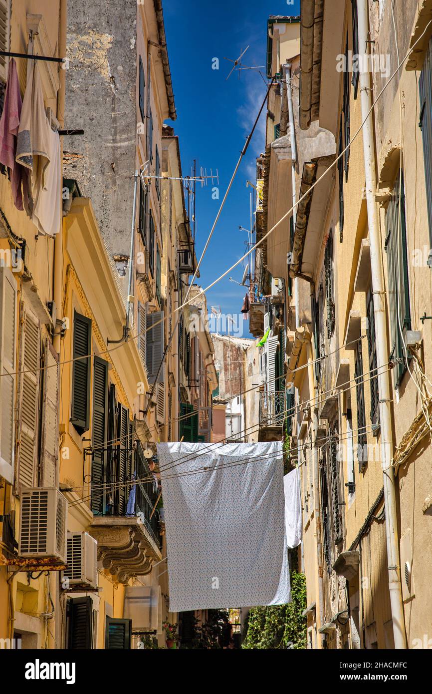The washed laundry is dried on the clothesline in narrow streets of ...