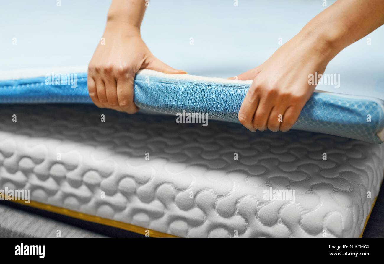 Woman hand testing orthopedic memory foam mattress topper Stock Photo ...