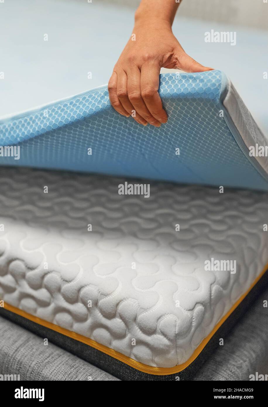 Woman hand testing orthopedic memory foam mattress topper Stock Photo ...