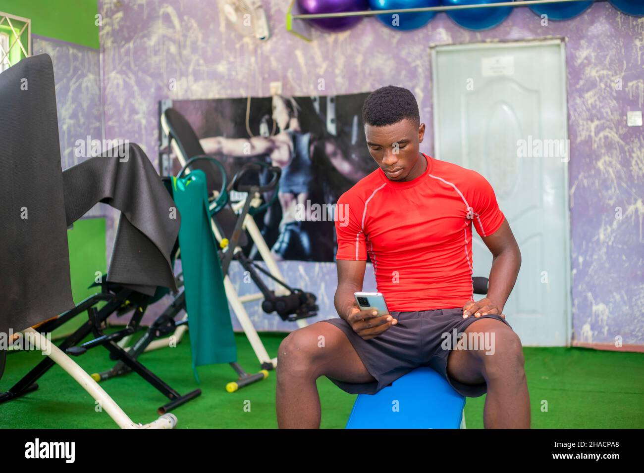guy in the gym operating his cellphone Stock Photo - Alamy