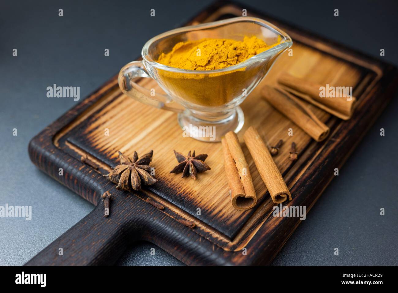spicy dry turmeric with cinnamon sticks on a wooden board Stock Photo ...
