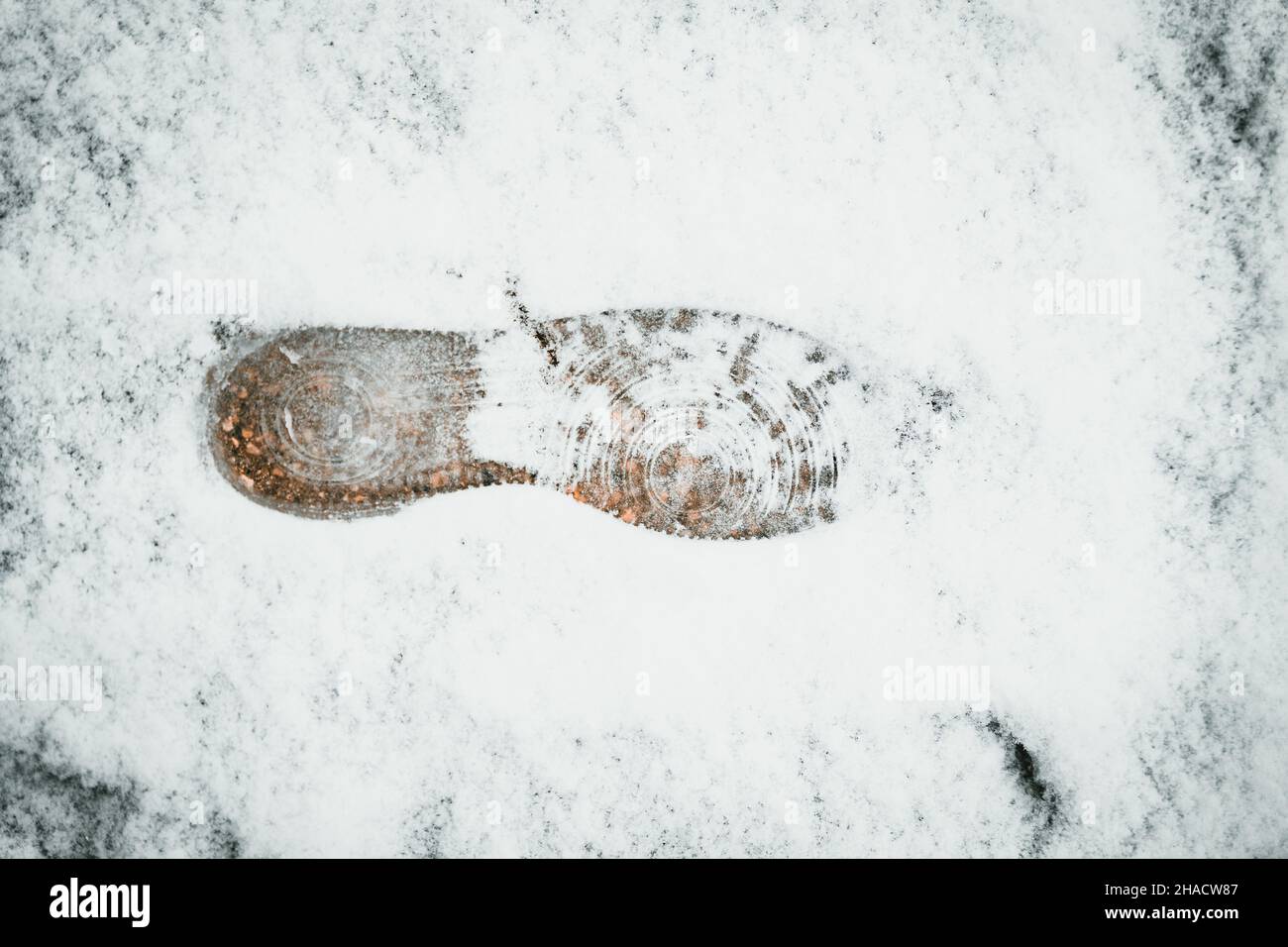 A top view shot of a footprint in snow during the day Stock Photo - Alamy