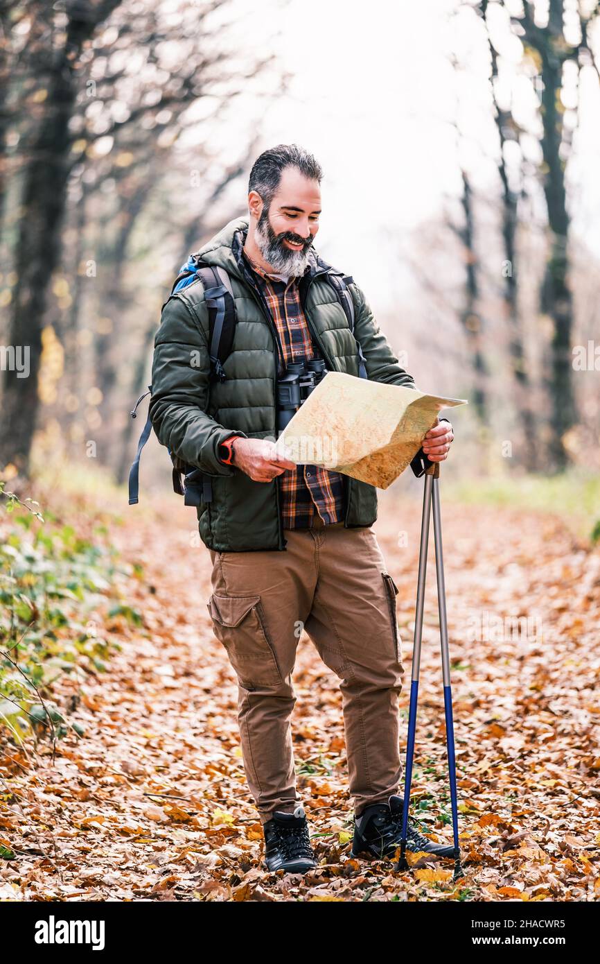Image of man hiking and looking at map Stock Photo - Alamy