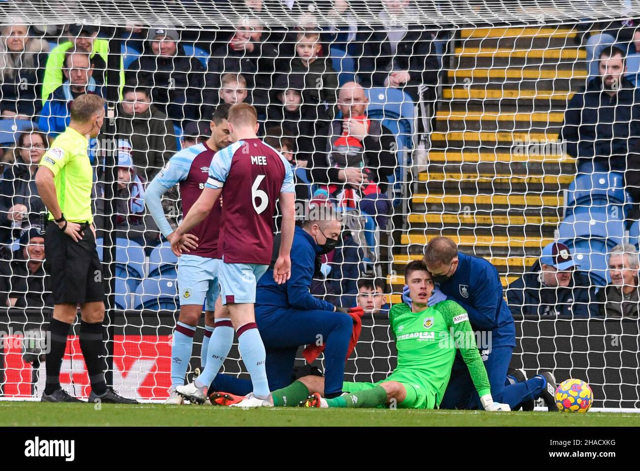 Nick Pope #1 of Burnley receives treatment on the pitch after an injury ...