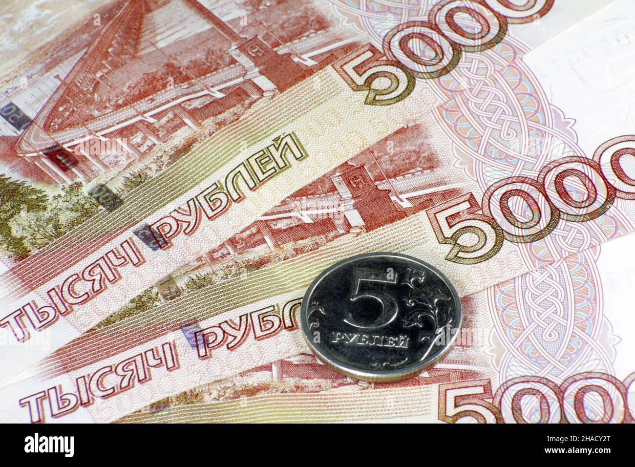 stack of money bond 5000 and coin Stock Photo - Alamy