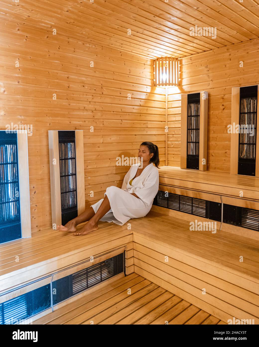 Asian woman mid age relaxing in infra red sauna, a woman doing spa ...