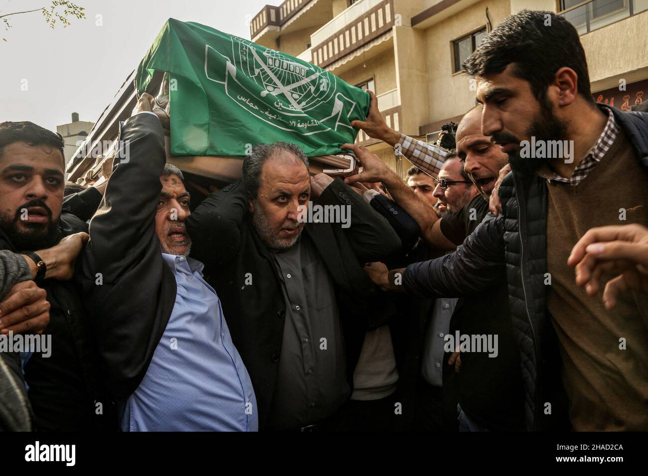 12 December 2021, Lebanon, Tyre: Mourners carry the coffin of Hamza ...