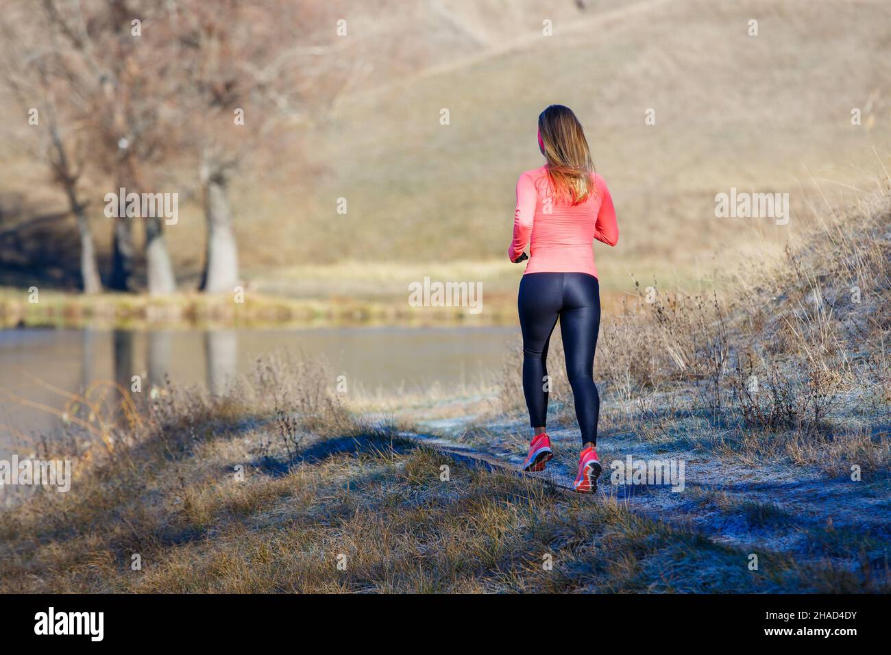 Rear view of running girl in the morning Stock Photo - Alamy