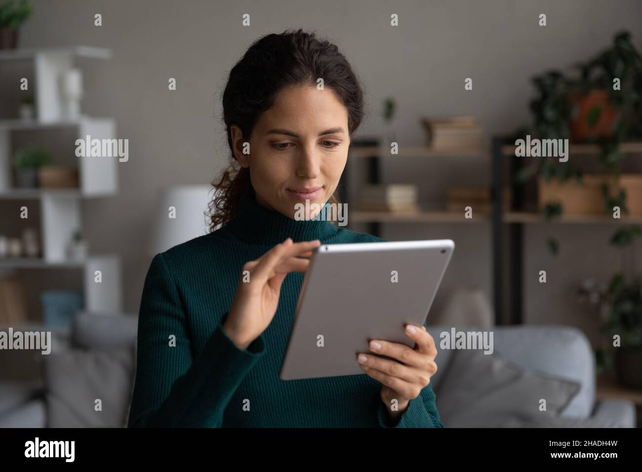 Latino woman use tablet browsing wireless internet Stock Photo - Alamy