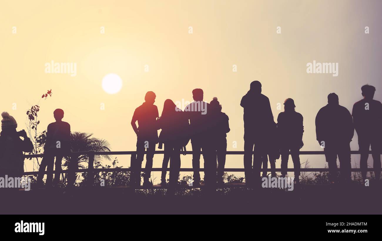 asians travel relax in the holiday.People stand looking at the sun in ...