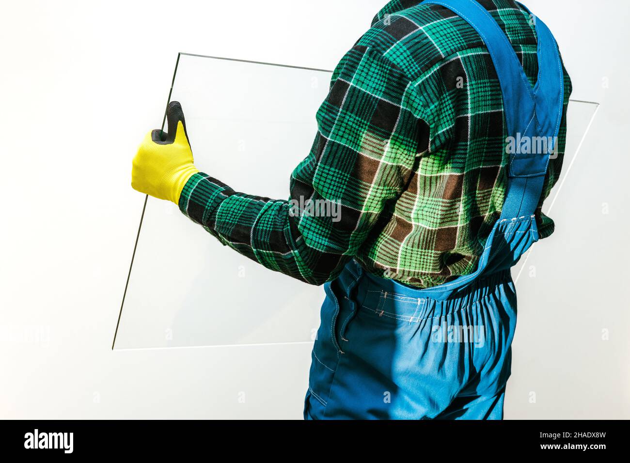 Glazier holding in his hands the panes of transparent glass Stock Photo ...