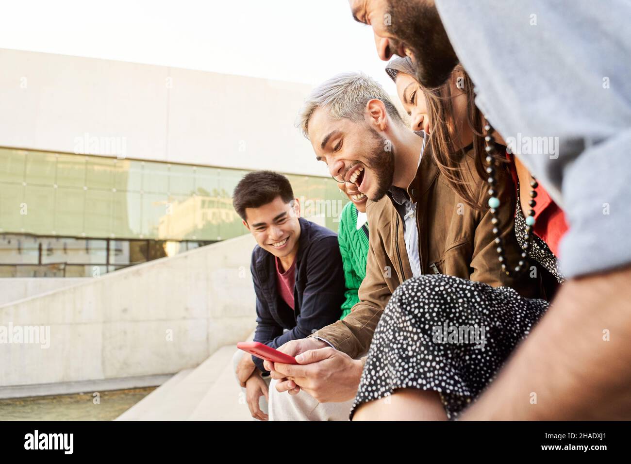 Group of happy friends using phones Stock Photo - Alamy