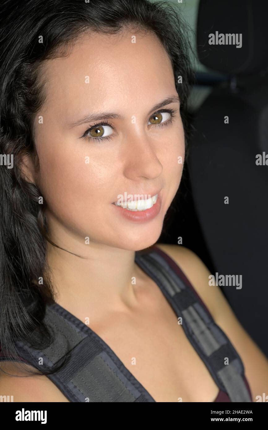 Young Woman In Car Restrained With A 5 Point Harness For Persons With