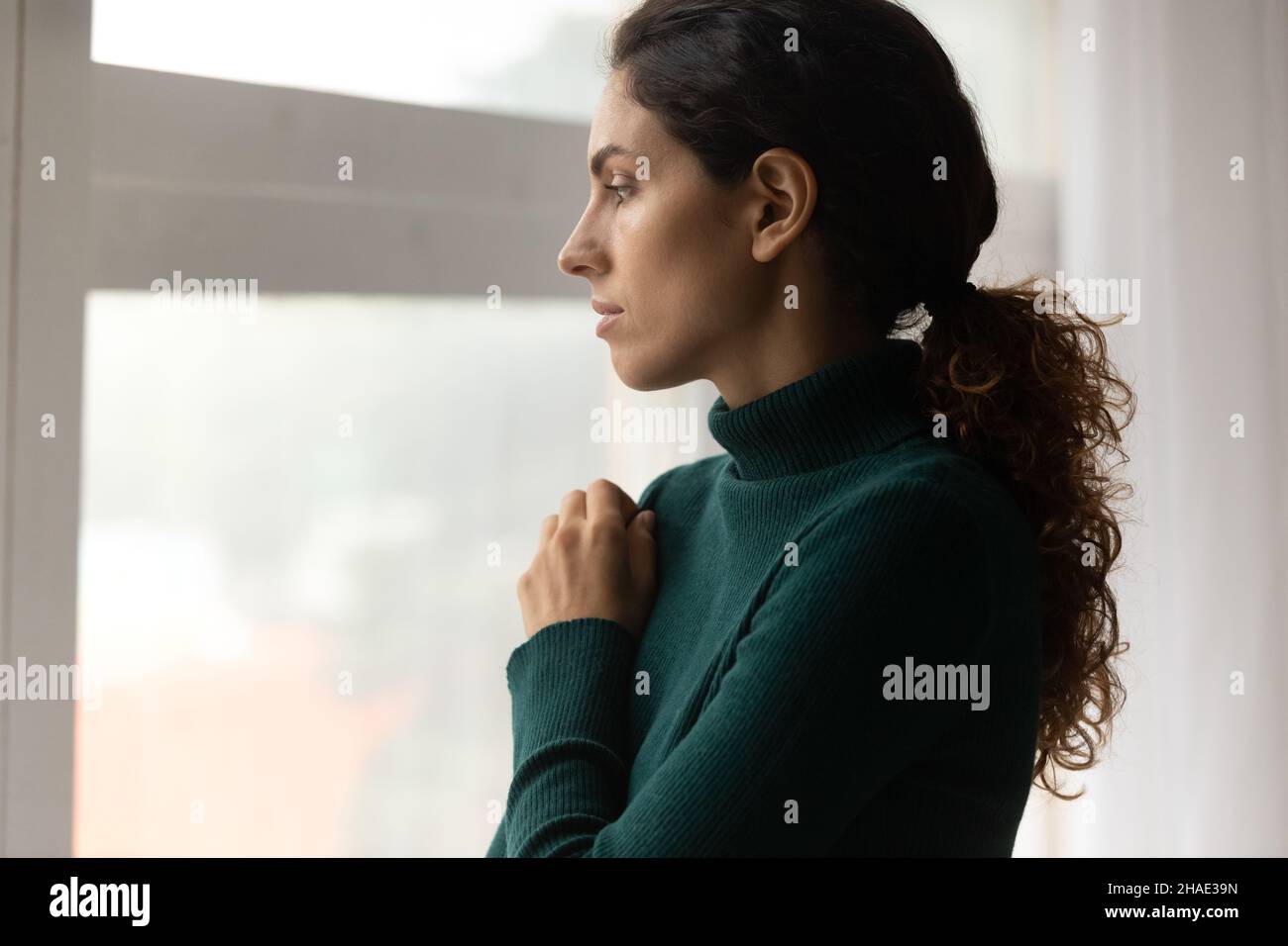 Sad woman look in window feel lonely at home Stock Photo - Alamy