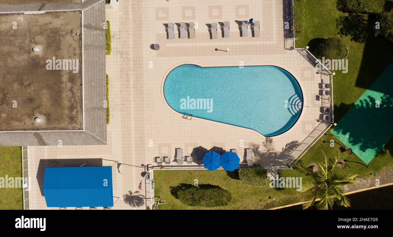 An Aerial view of a big outdoor pool in a resort area under sunlight ...