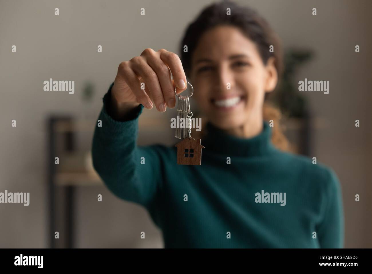 Close up of woman show keys to new home Stock Photo - Alamy