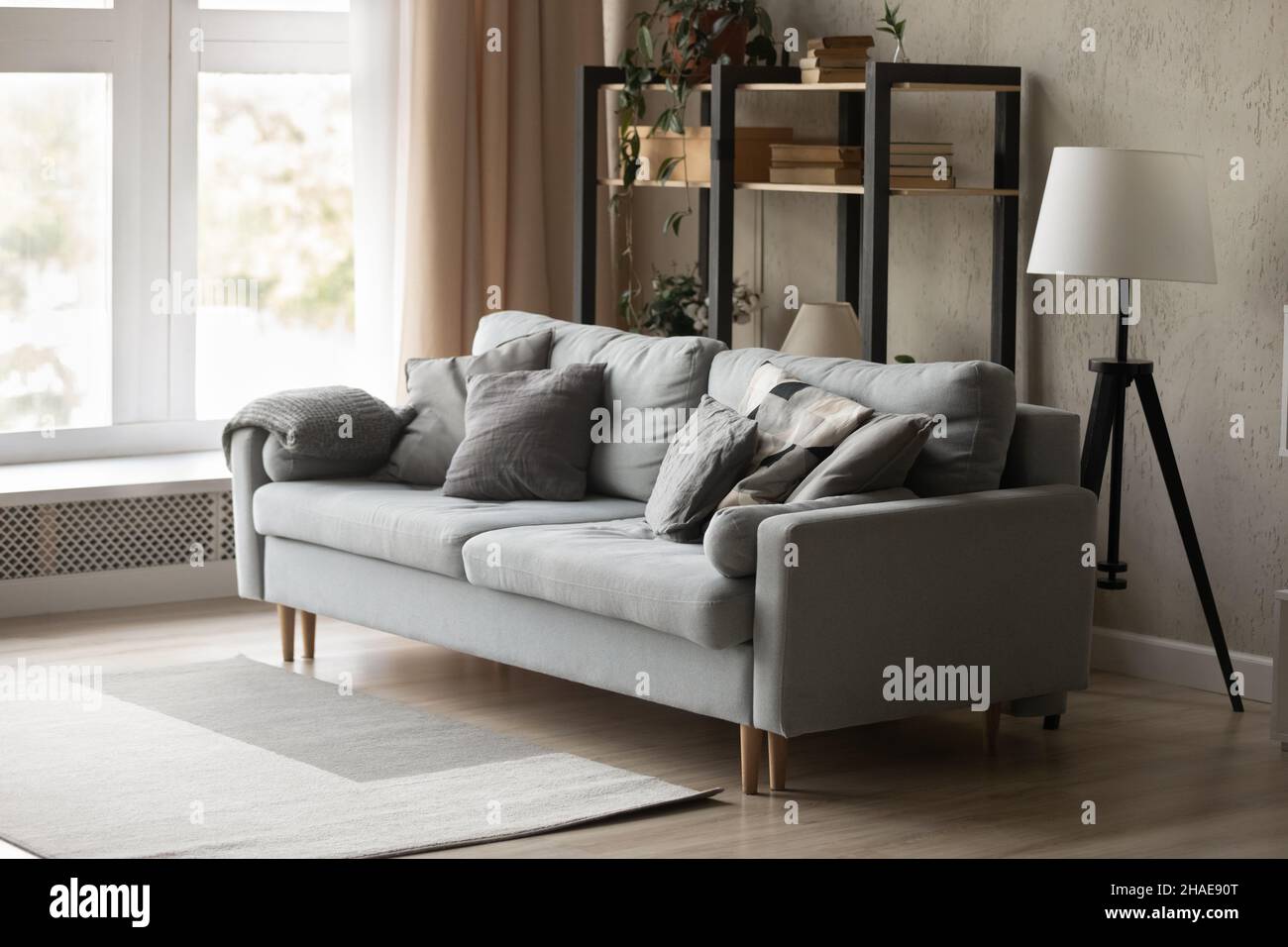 Empty cozy sofa in design living room Stock Photo - Alamy