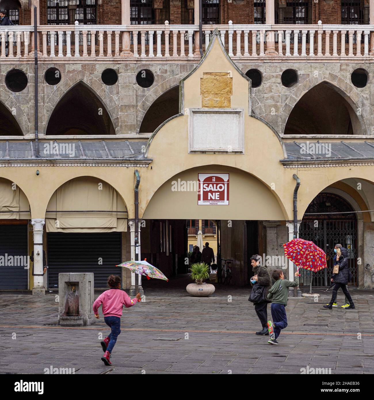 A girl and a boy play on a court. They jump back and forth, holding up ...