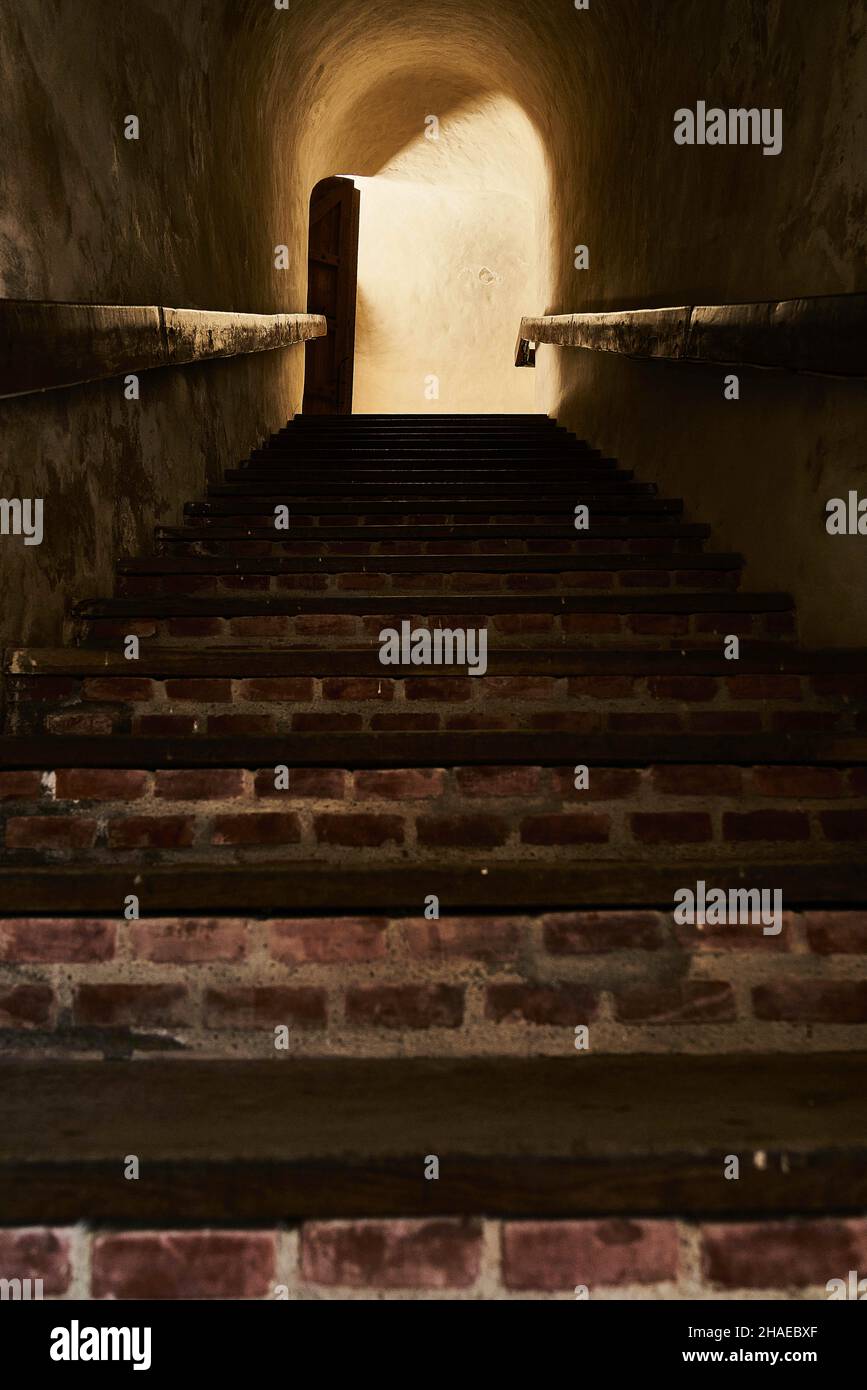 A beautiful scene of old stony stairs leading up to an open wooden door ...