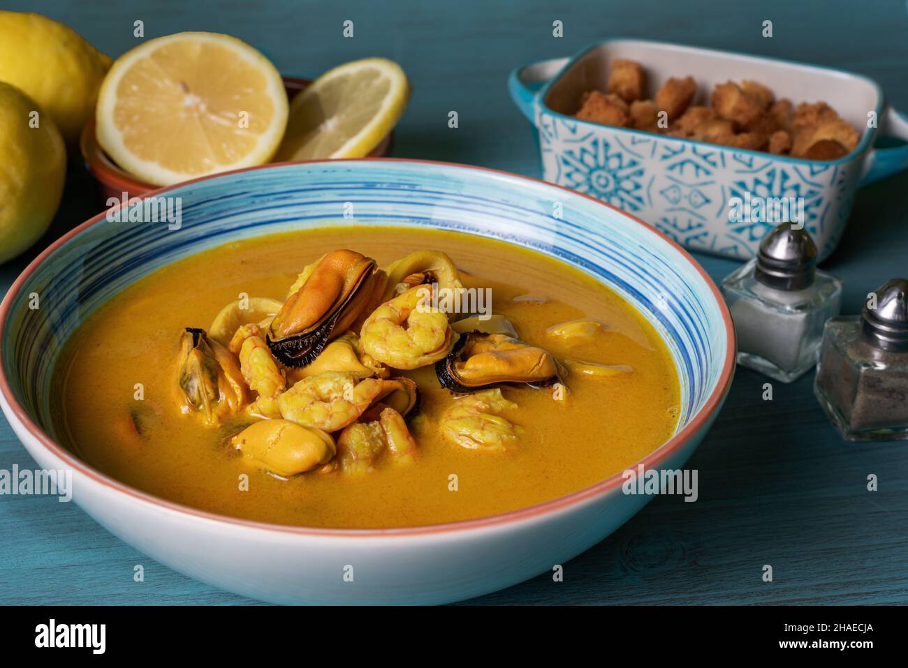 Seafood soup, based on prawns, mussels, clams, hake and squid, served ...