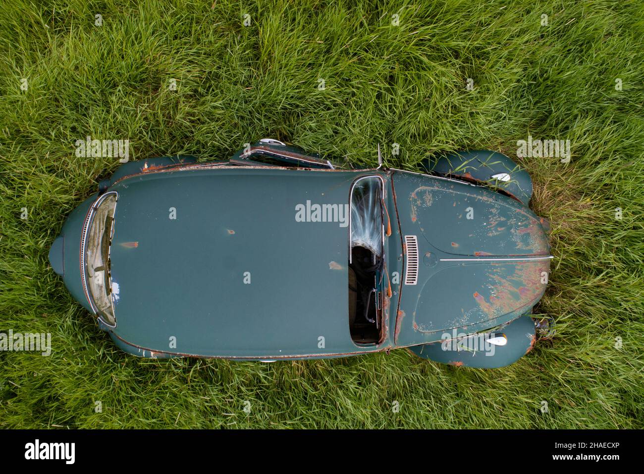 Birds eye view of a old ruined and rusty old car standing abandoned in ...