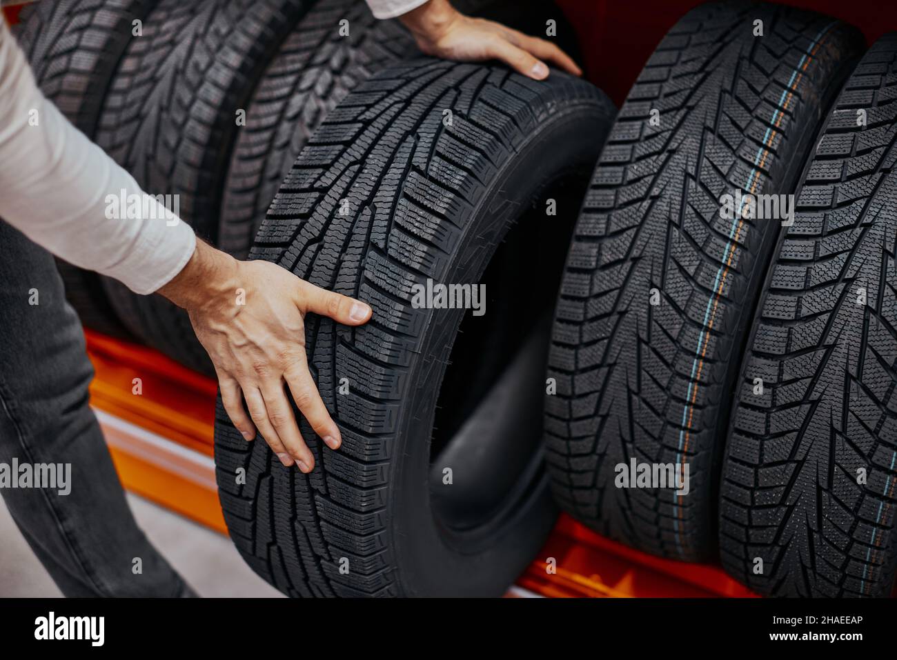 close-up of a man's hand with car tires Stock Photo - Alamy