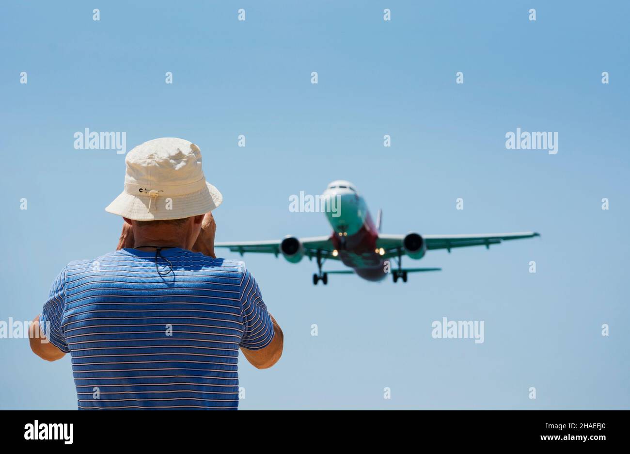 Capturing photos of landing airliner. Plane spotting is a hobby of ...