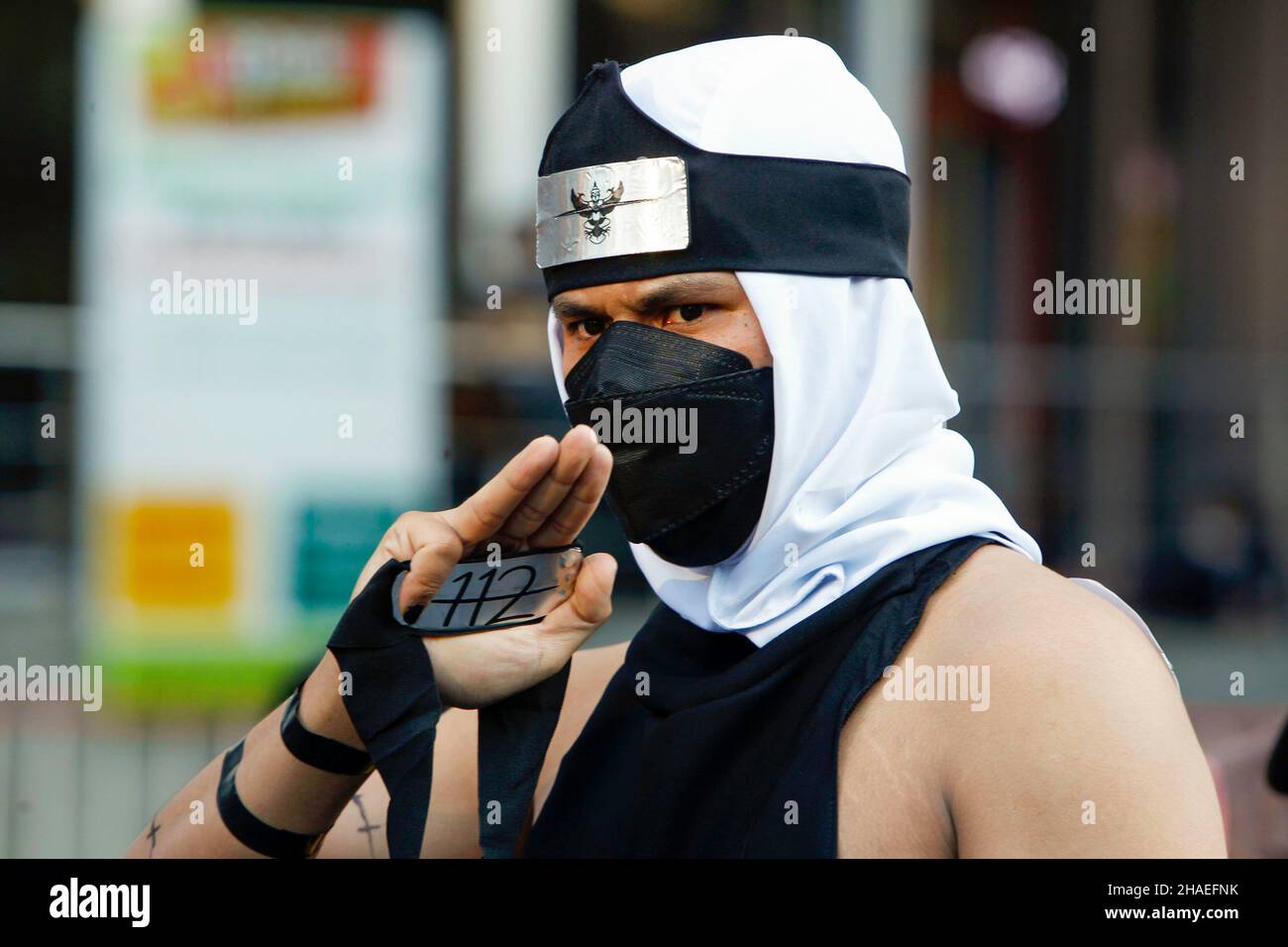 A protester wearing a face mask gestures during the demonstration ...