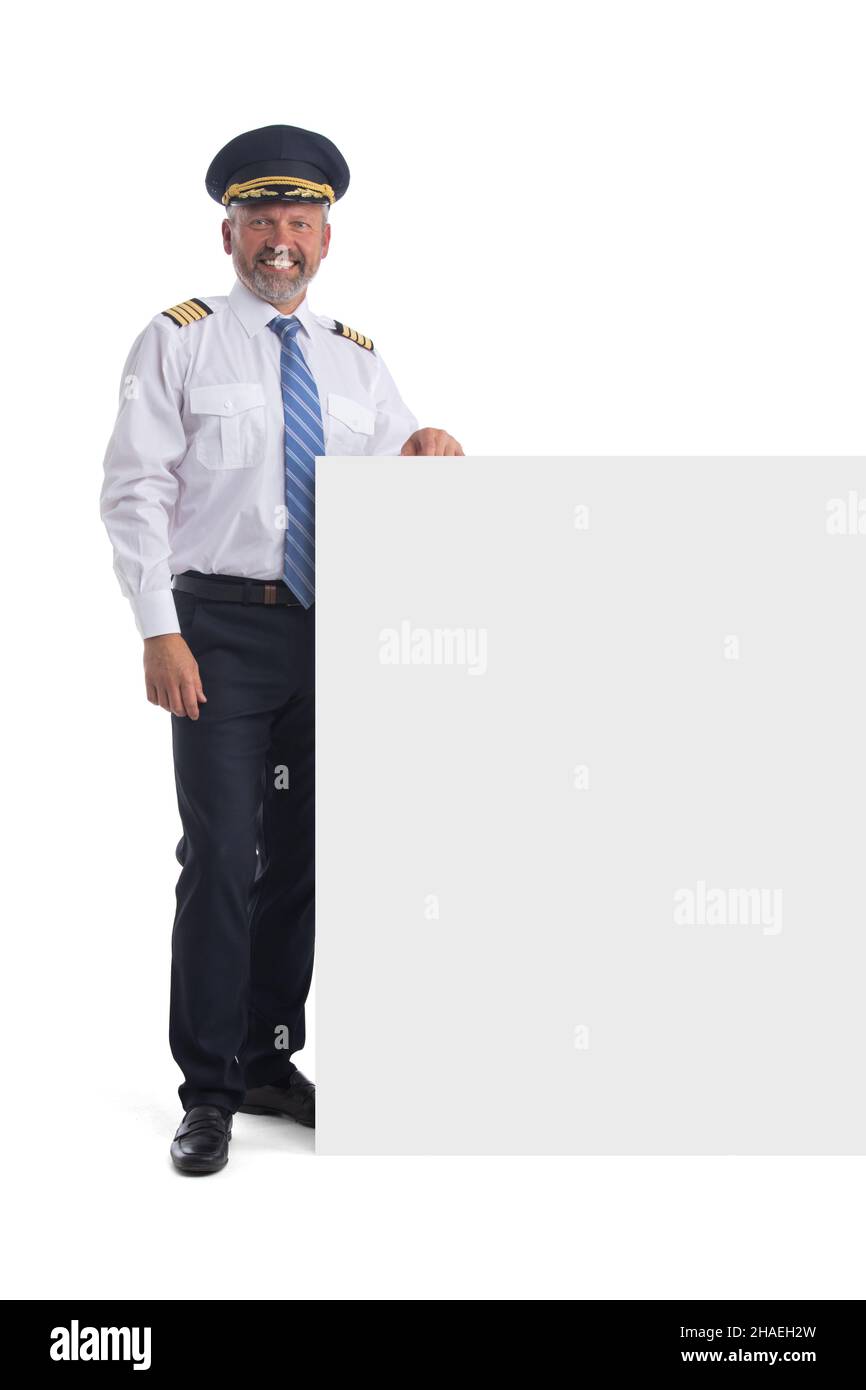 Portrait of happy smiling pilot holds blank banner isolated on white ...