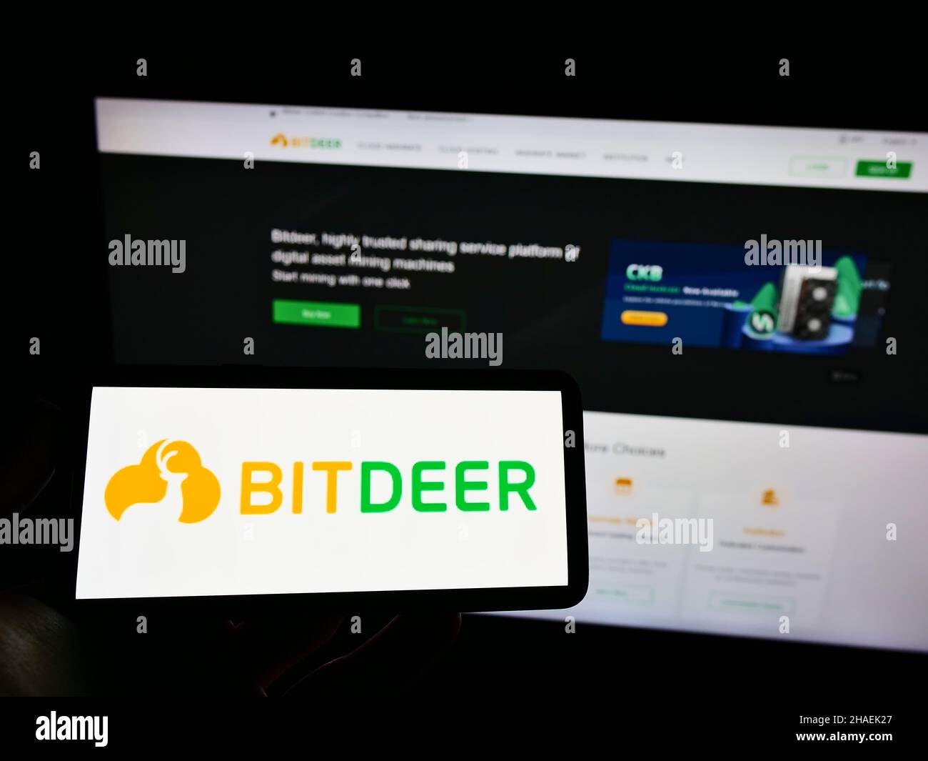 Person holding mobile phone with logo of Singaporean blockchain mining ...