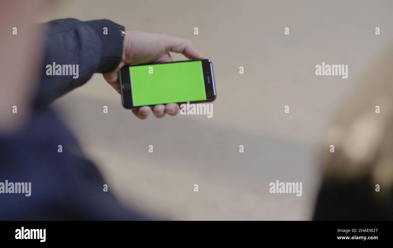 Man shows to his friend new app on his mobile phone. Phone with ...