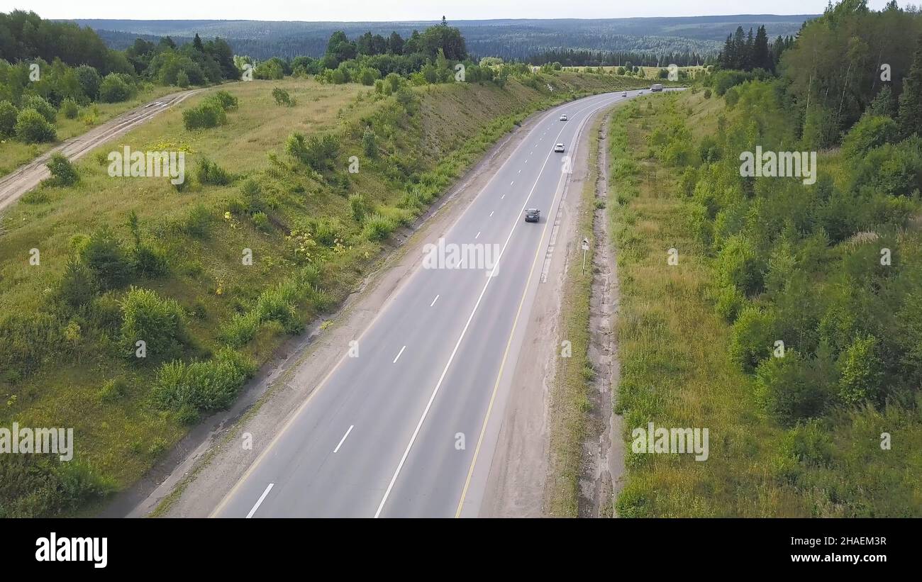 Top view of rural road. Clip. Rural highway with traffic in forest ...