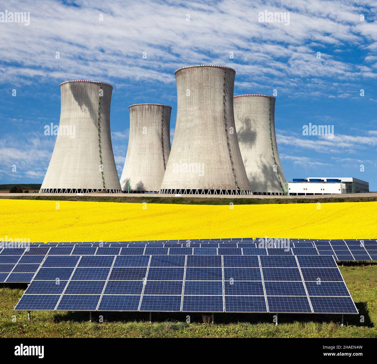 Nuclear power plant with golden flowering field of rapeseed and ...