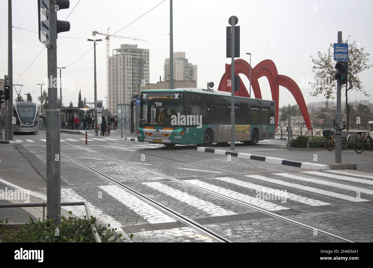 Bus crossing the intersection while the Light Rail waits at the Mount ...
