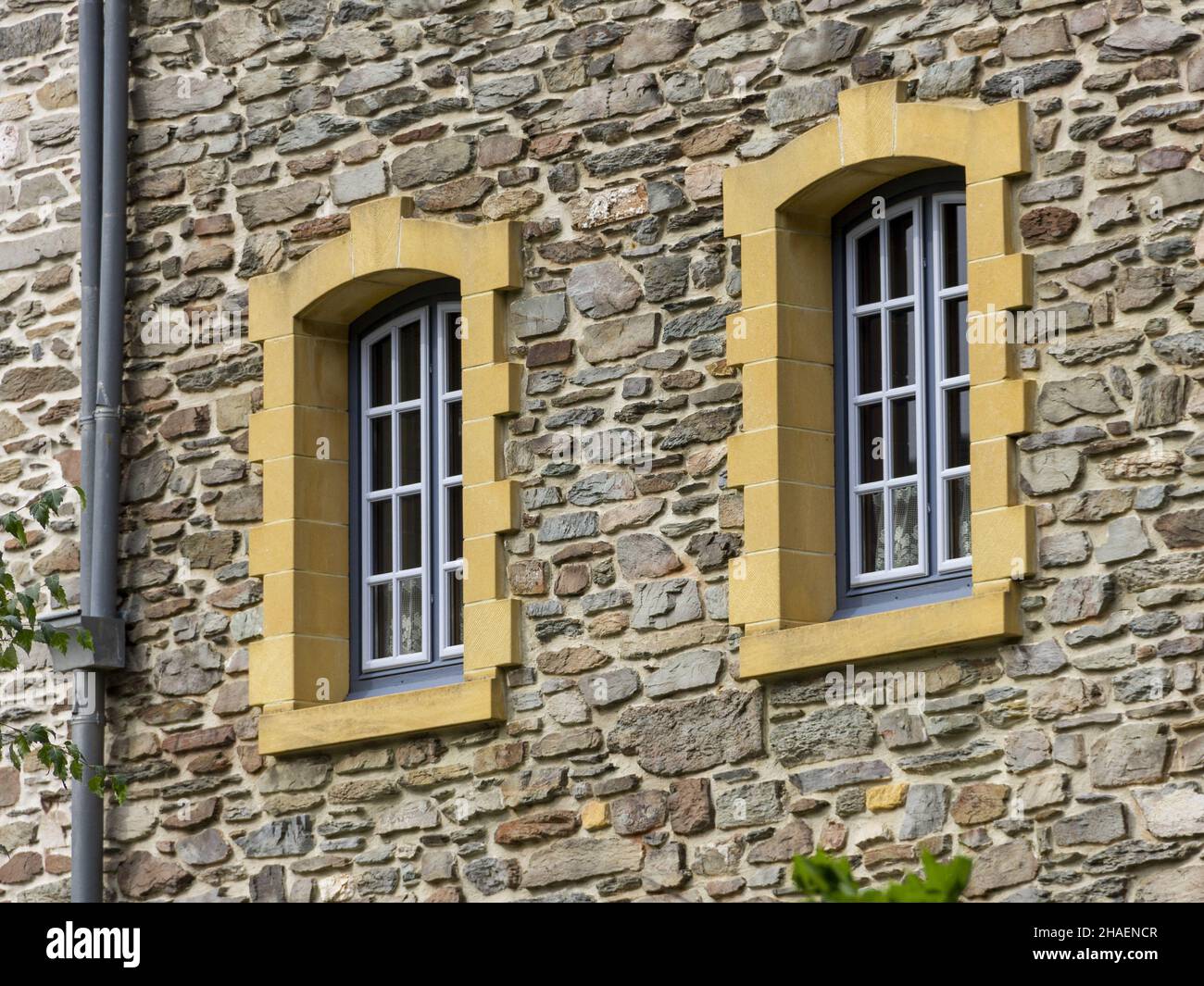 A closeup of the stoned wall with two old fashioned windows Stock Photo ...
