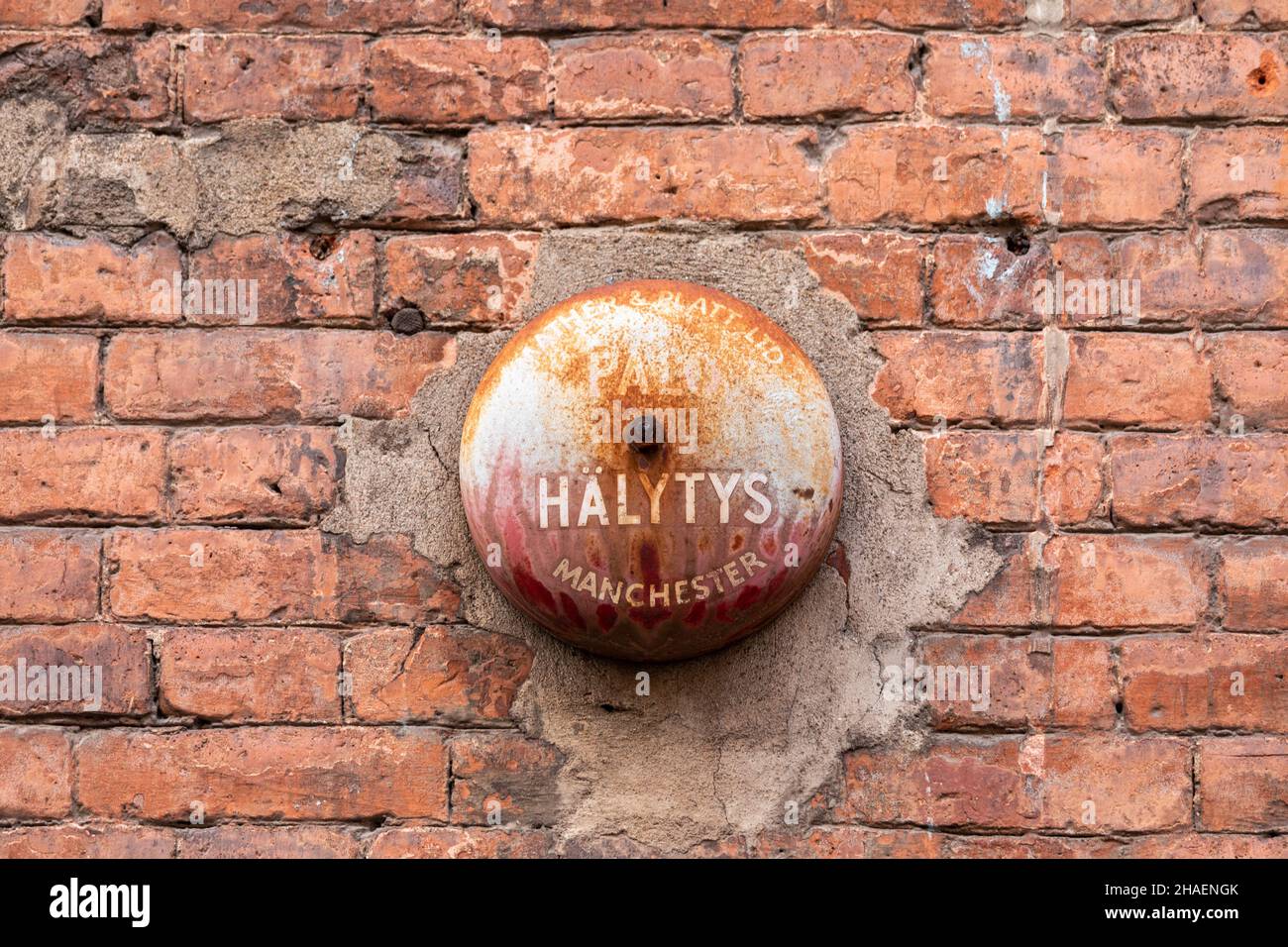 Old fire alarm bell by Mather & Platt Ltd on industrial brick building ...