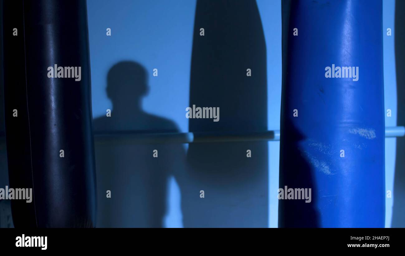 Man athlete standing and doing shadow boxing exercises in gym. Boxer ...