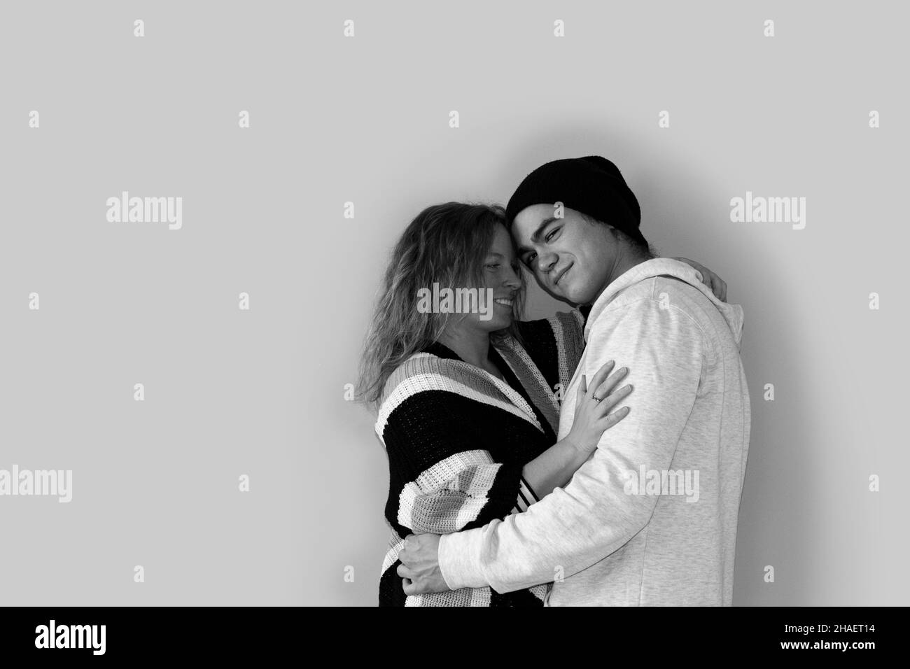 greyscale photo of couple embracing, light grey background Stock Photo ...