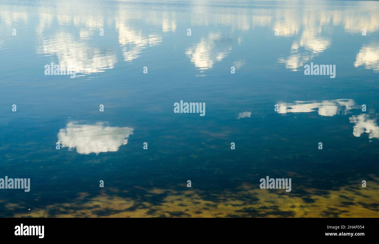 Clouds reflection in pure lake water, heaven and clouds in water Stock ...