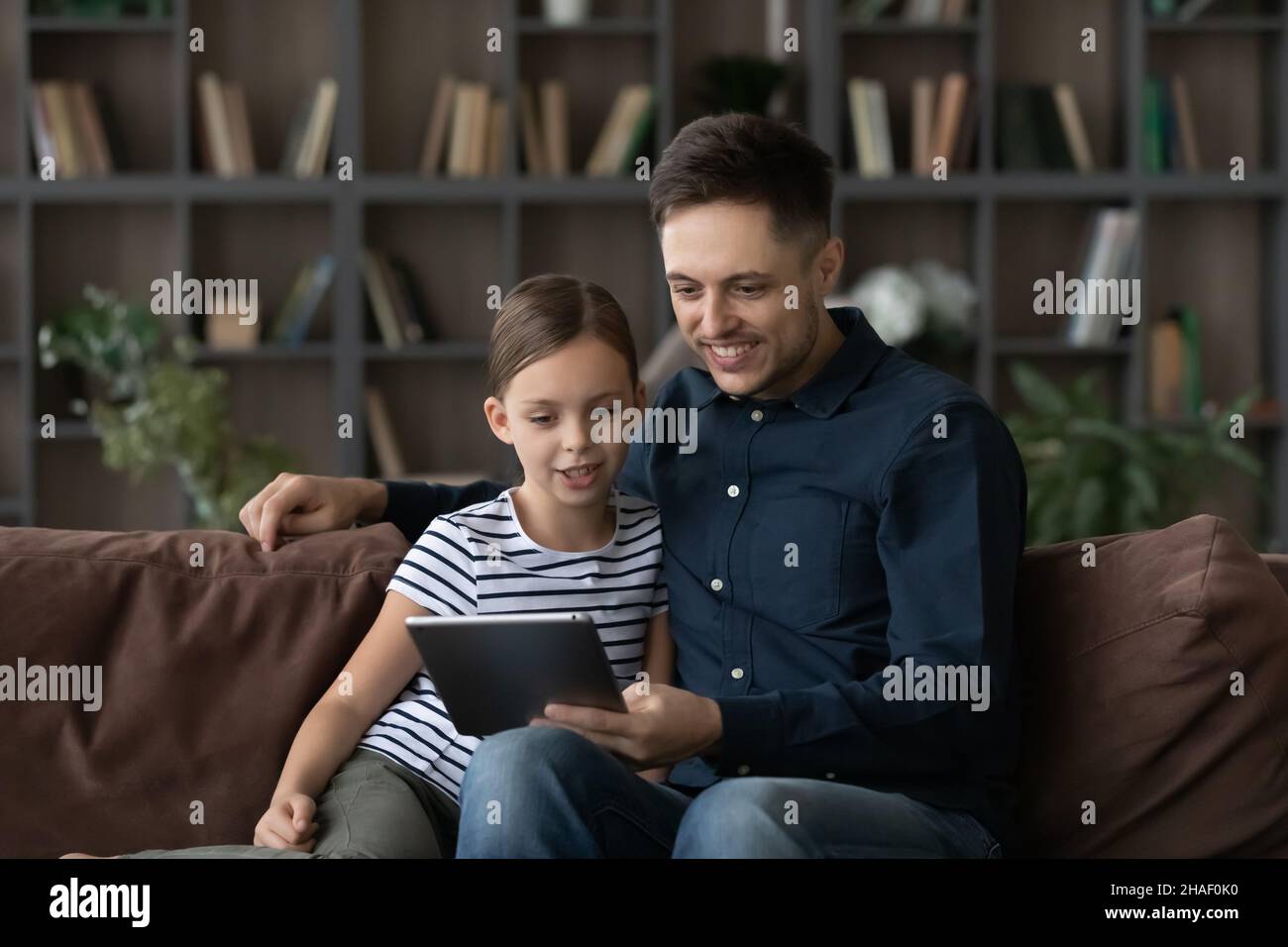 Happy bonding family using digital computer tablet Stock Photo - Alamy