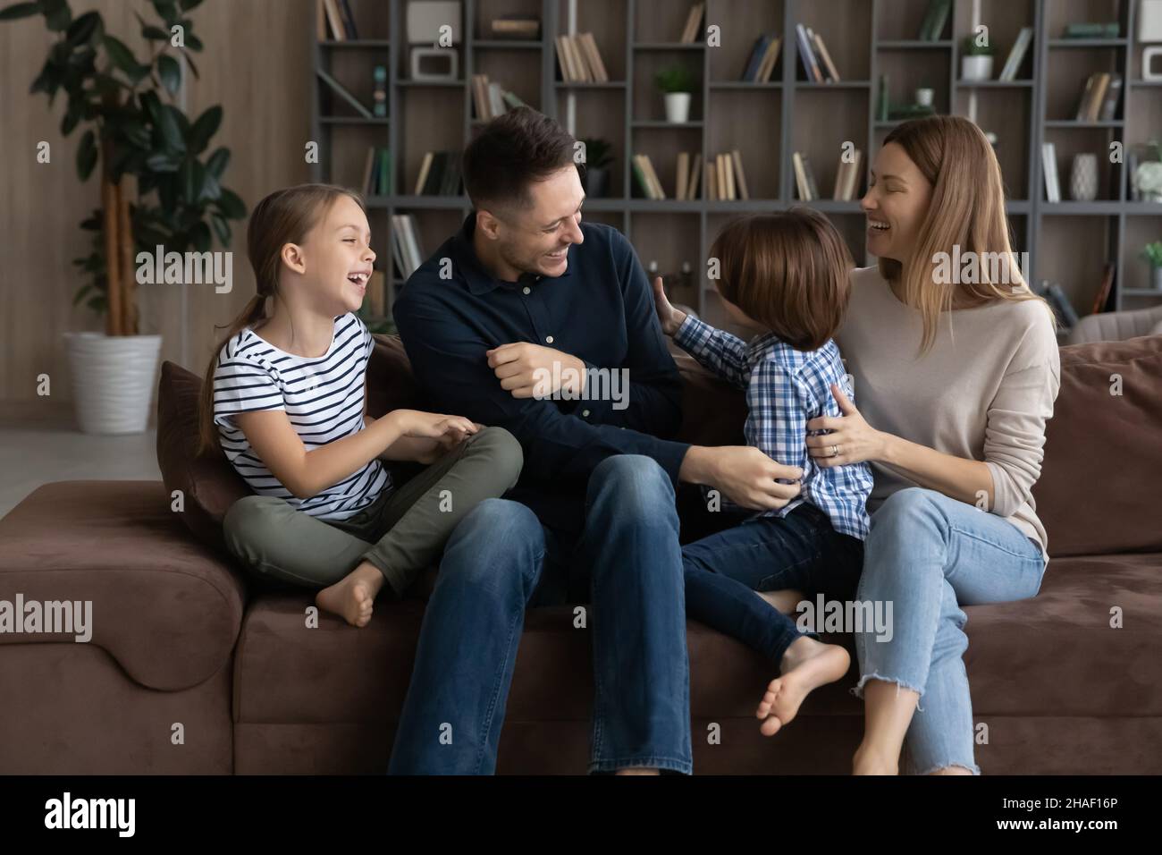 Happy two generations family playing together at home Stock Photo - Alamy