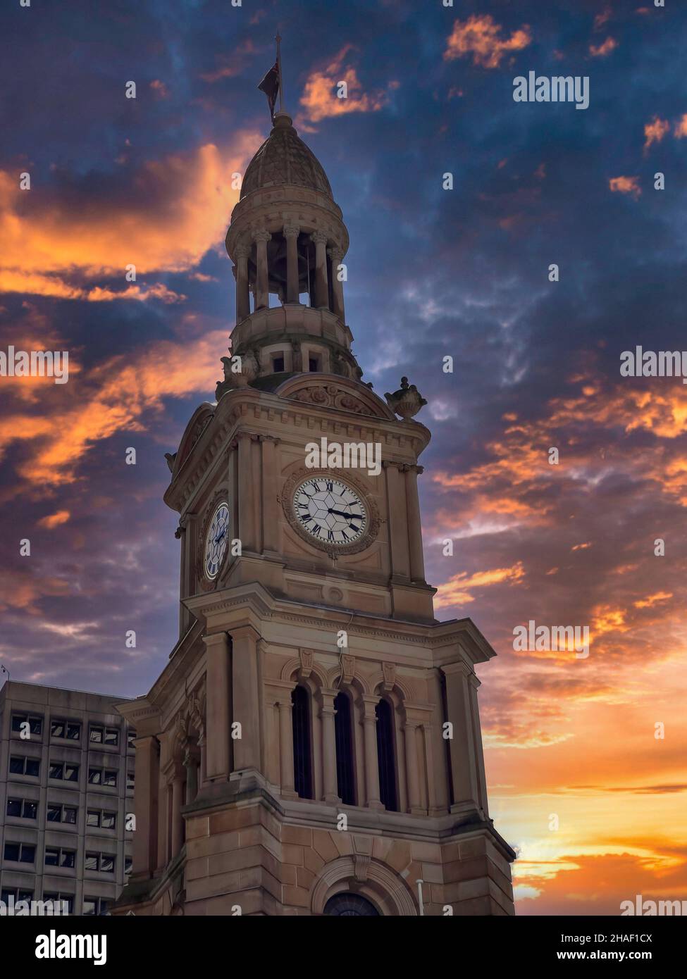 historic Paddington Town Hall clock tower under dark cloudy sunset sky ...