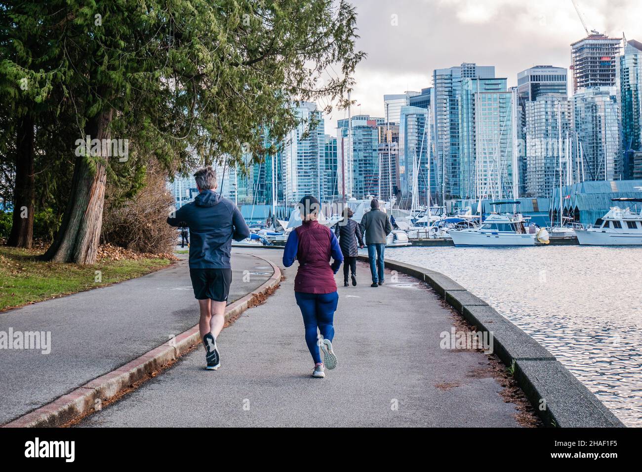 a couple jogging along a pathway in stanley park vancouver canada Stock ...